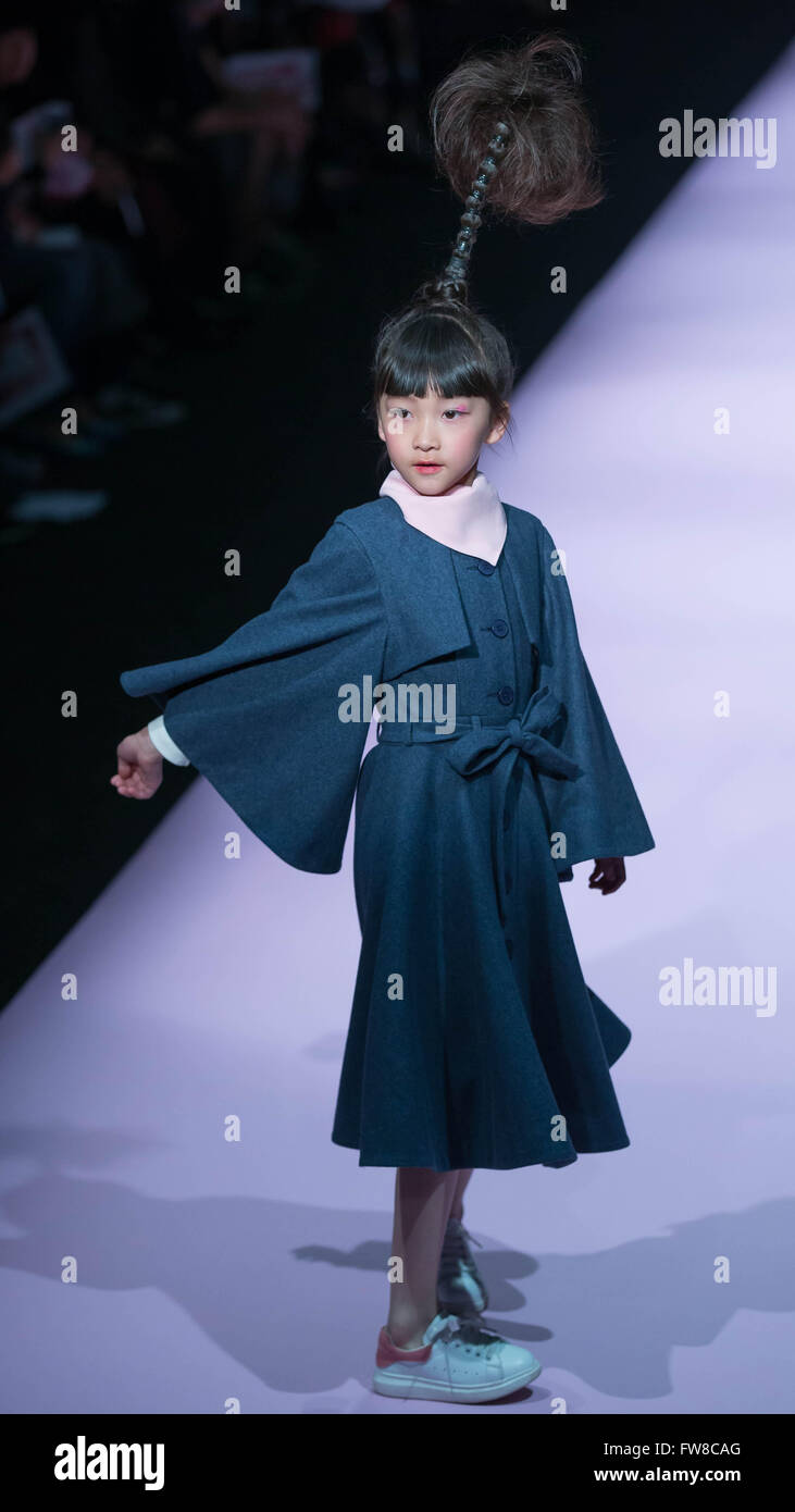 Beijing, China. 31st Mar, 2016. A child presents a creation by designer ...