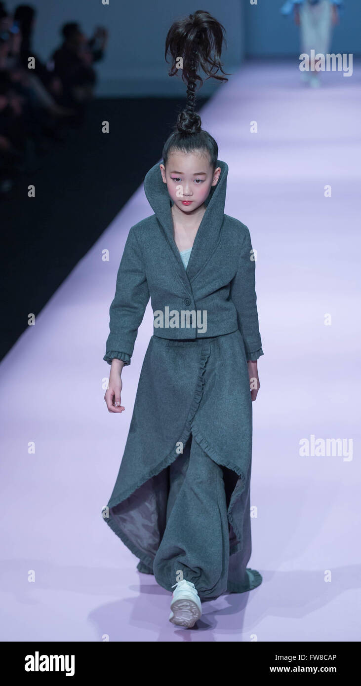 Beijing, China. 31st Mar, 2016. A child presents a creation by designer ...