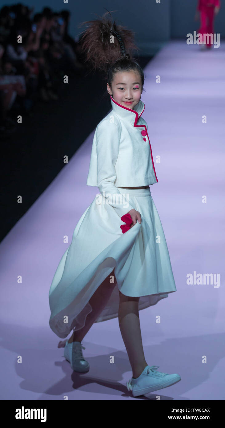 Beijing, China. 31st Mar, 2016. A child presents a creation by designer ...