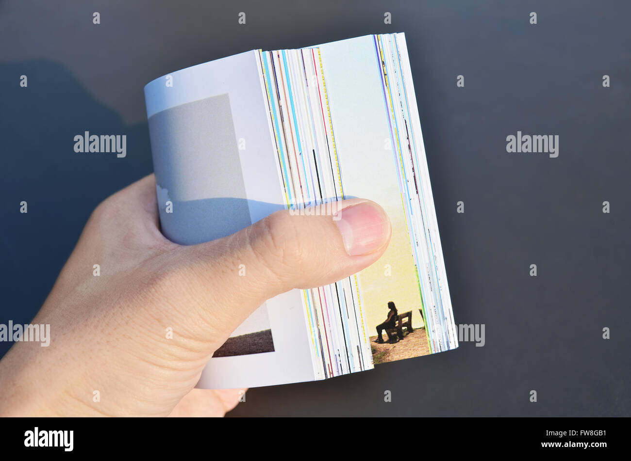 Hand is pressing on the side of the book showing a random page Stock ...