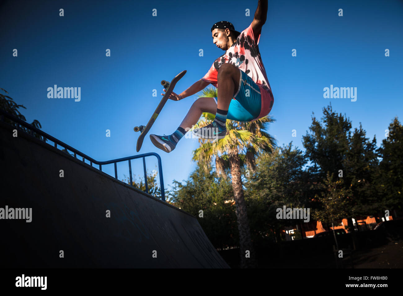 Young man roller skating at a skate park Stock Photo - Alamy