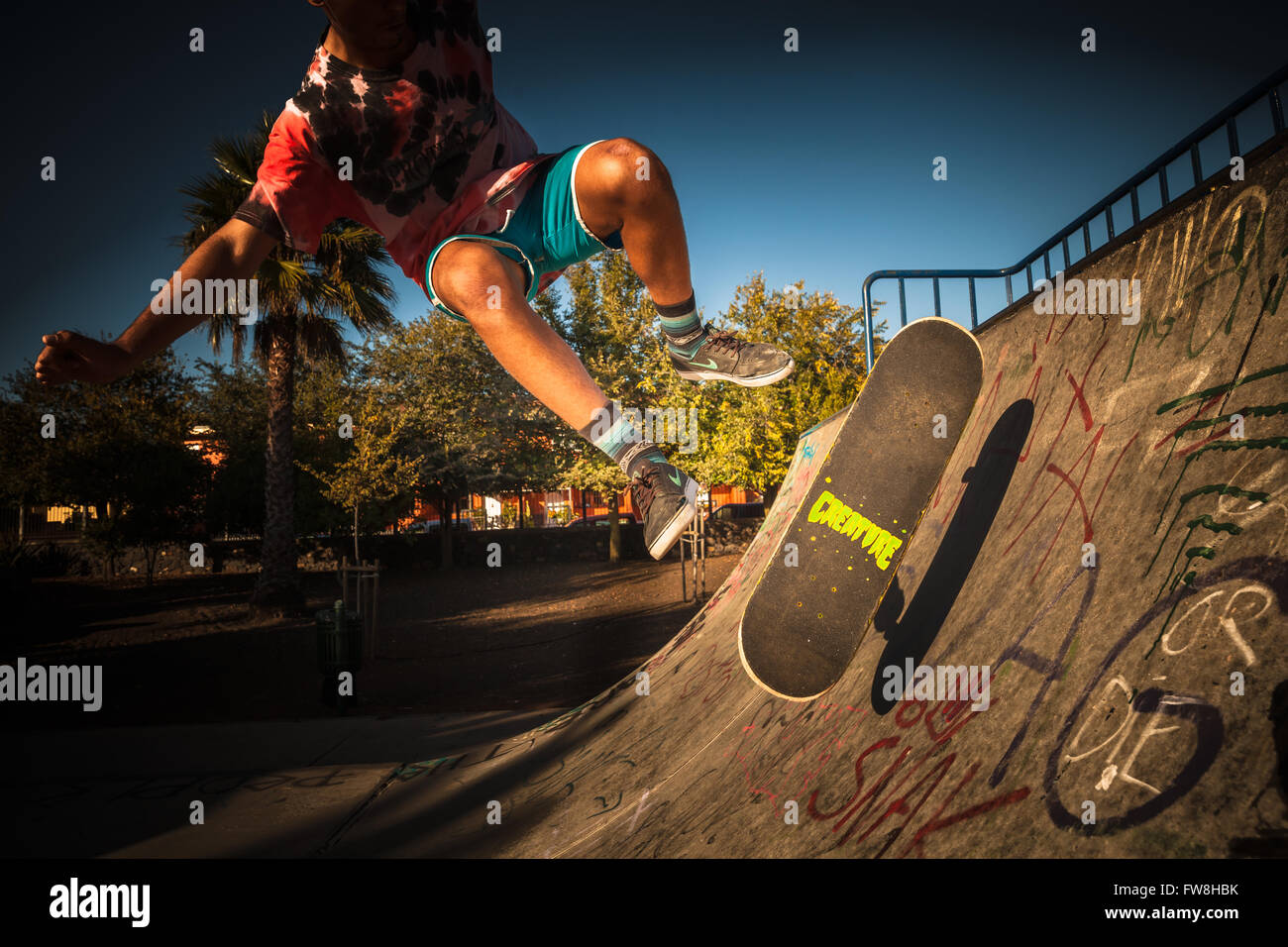 Young man roller skating at a skate park Stock Photo - Alamy