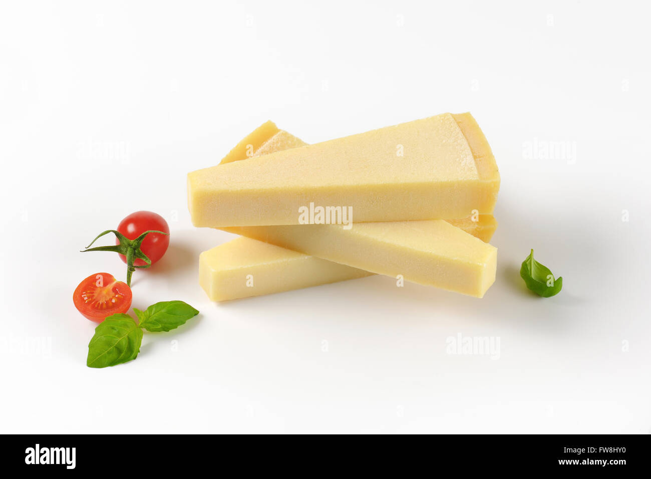 three wedges of fresh parmesan cheese on white background Stock Photo ...