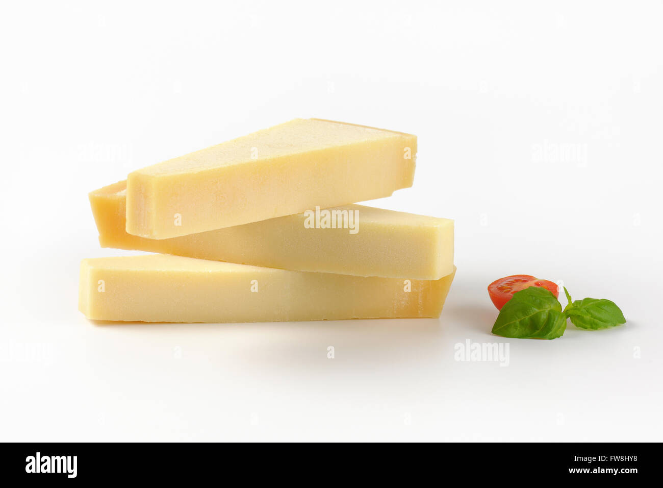 three wedges of fresh parmesan cheese on white background Stock Photo ...