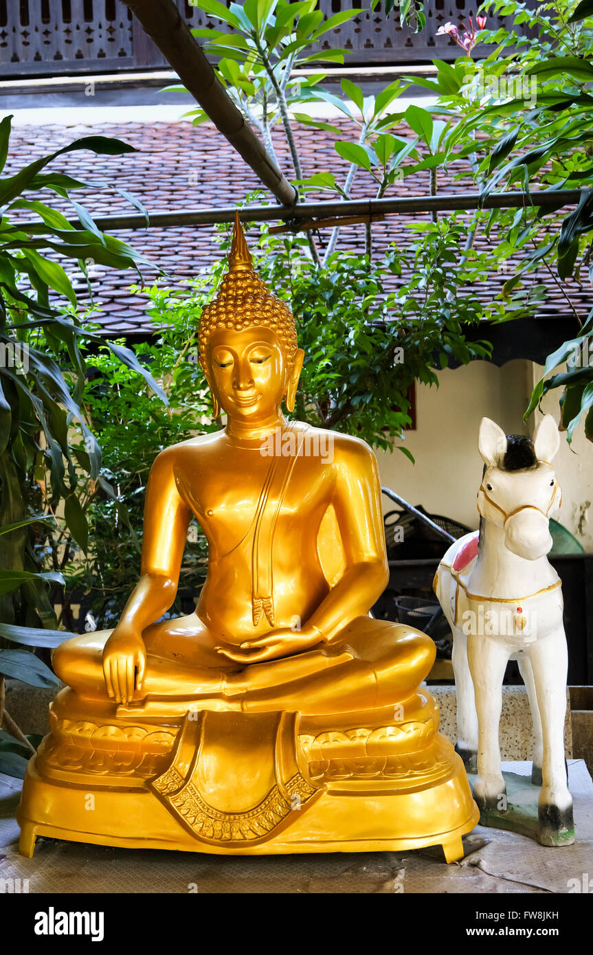 Golden plastic Buddha with white plastic horse Stock Photo - Alamy