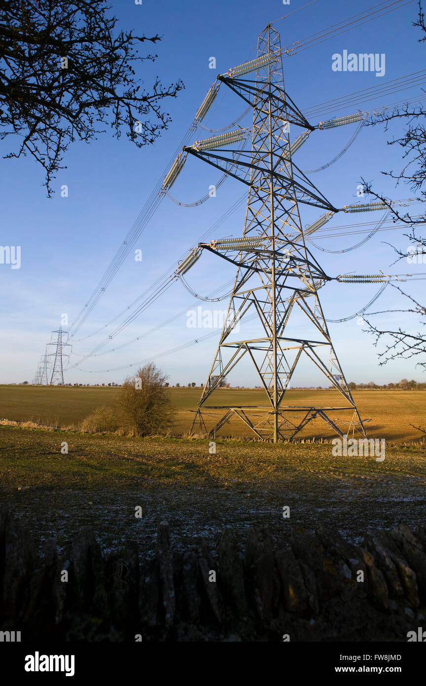 Electric pylons against a blue sky Stock Photo - Alamy
