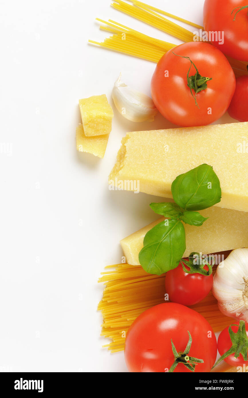 fresh parmesan cheese, vegetable garnish and spaghetti on white ...