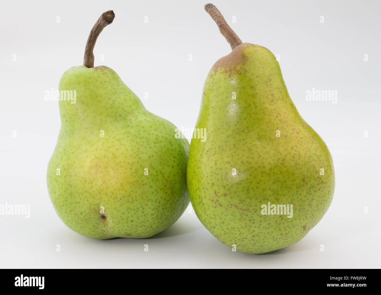 Two imperfect green pears isolated on white background Stock Photo - Alamy