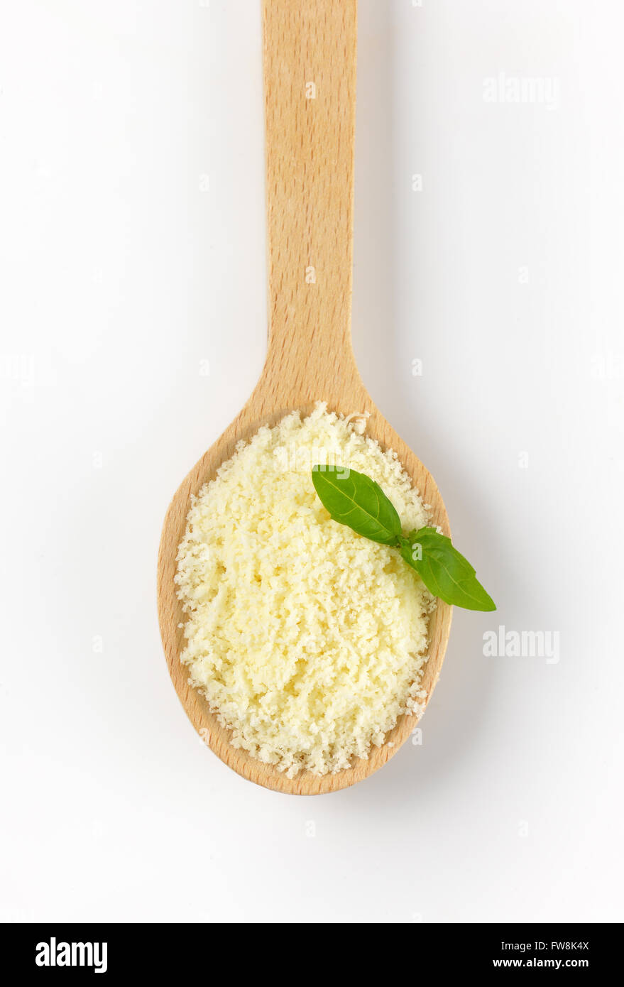 spoon of grated parmesan cheese with basil on white background Stock ...