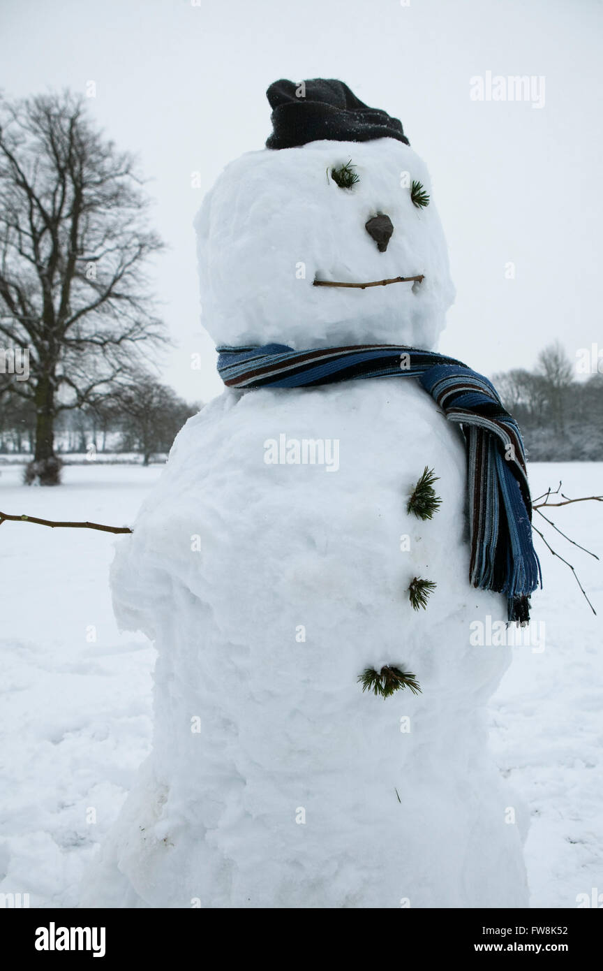 A snowman made in the freshly fallen snow of a British winter standing ...