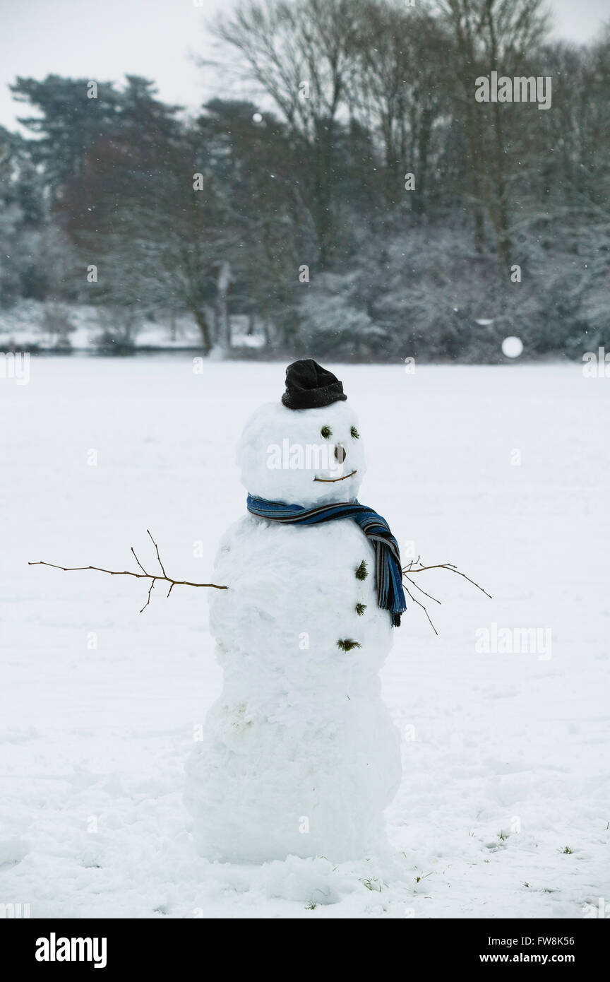 A snowman made in the freshly fallen snow of a British winter standing ...