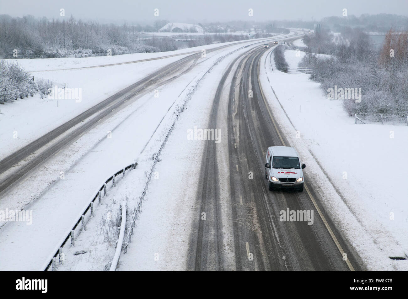 A view of the A419 / A417 by pass the covered in snow with vehicles ...
