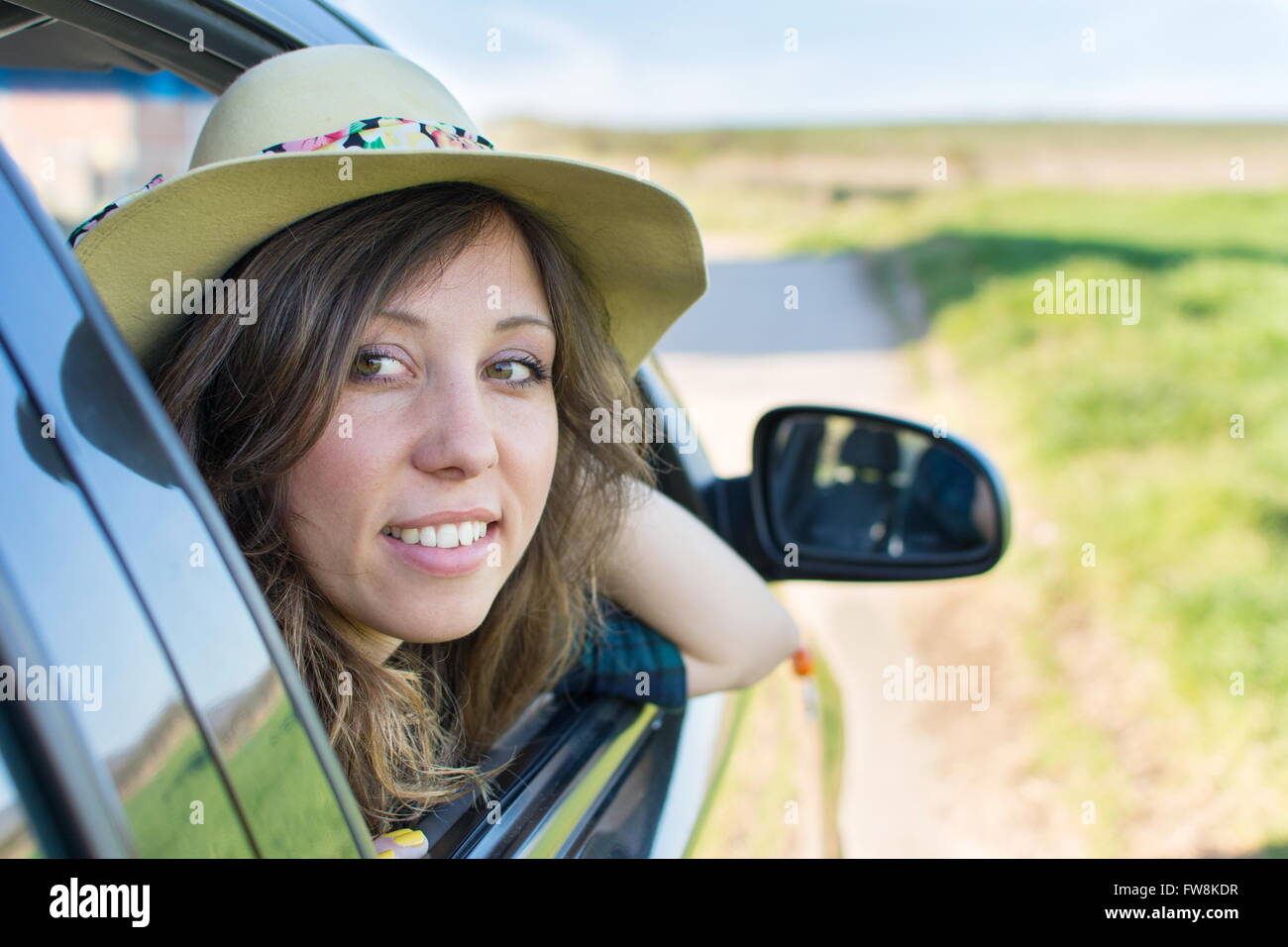 Woman looking thru car window on a road trip Stock Photo - Alamy