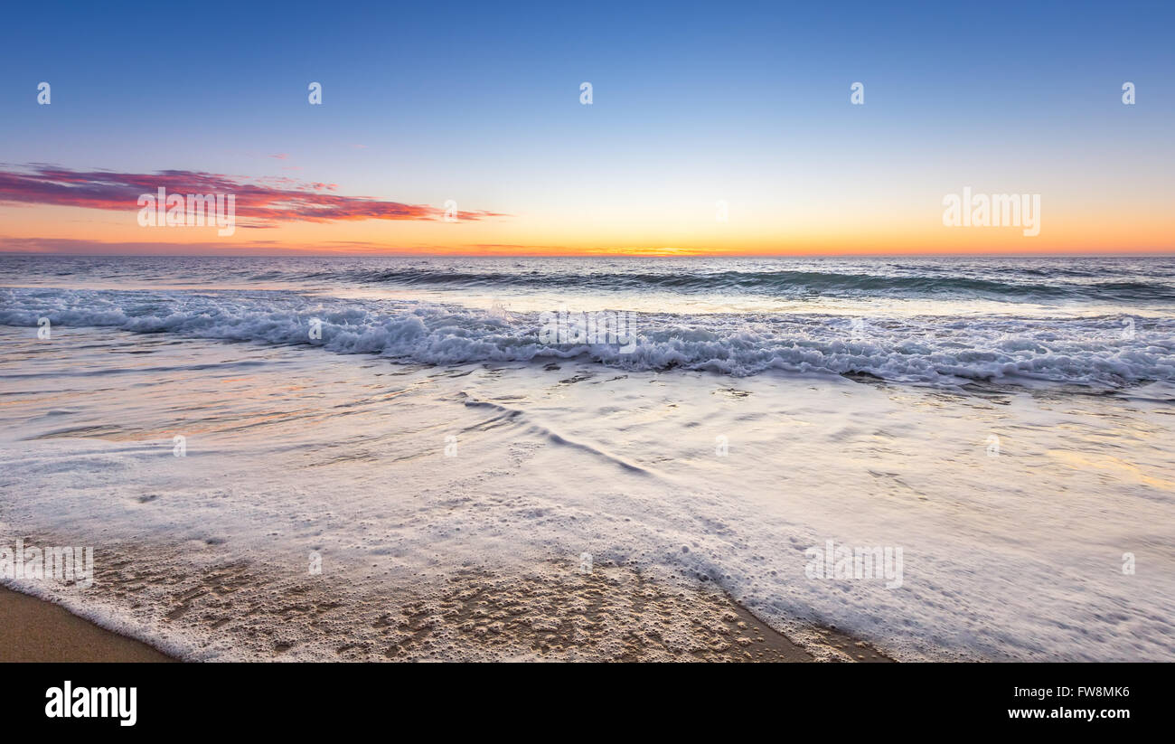 Sunrise on the beach Stock Photo - Alamy
