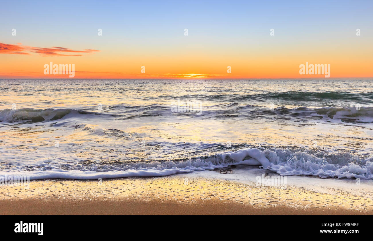 Sunrise on the beach Stock Photo - Alamy
