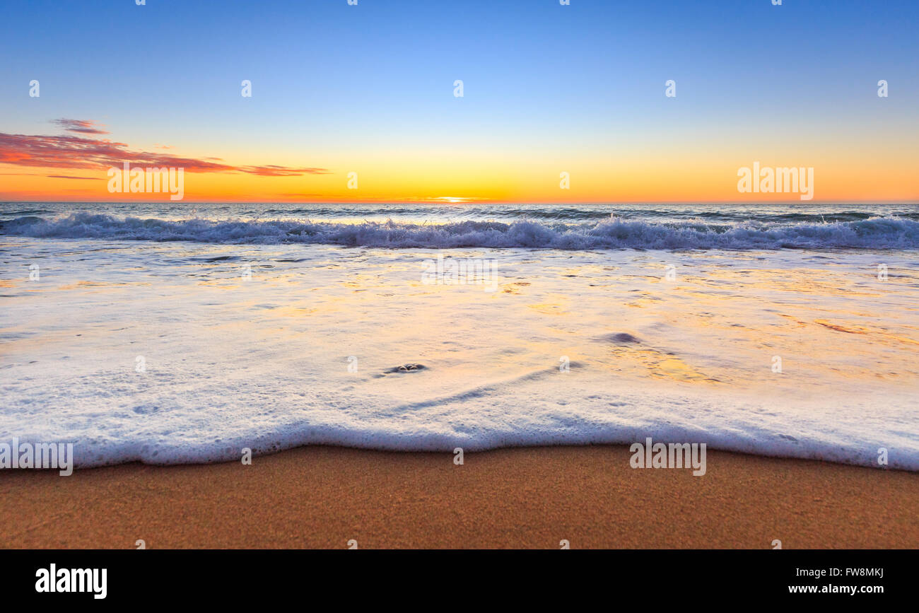 Sunrise on the beach Stock Photo - Alamy