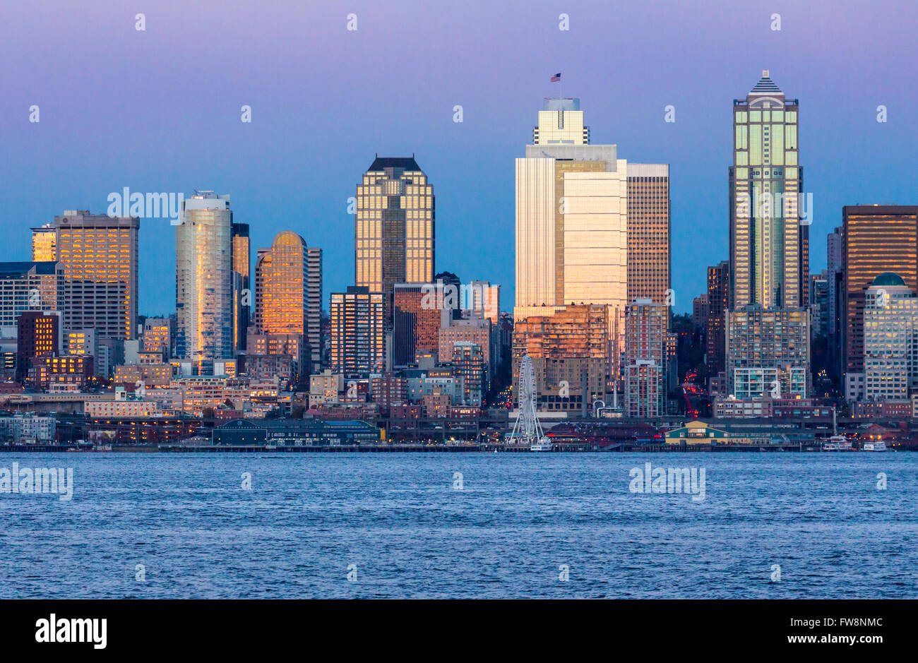 Seattle skyline, office buildings and Elliott Bay waterfront at sunset ...