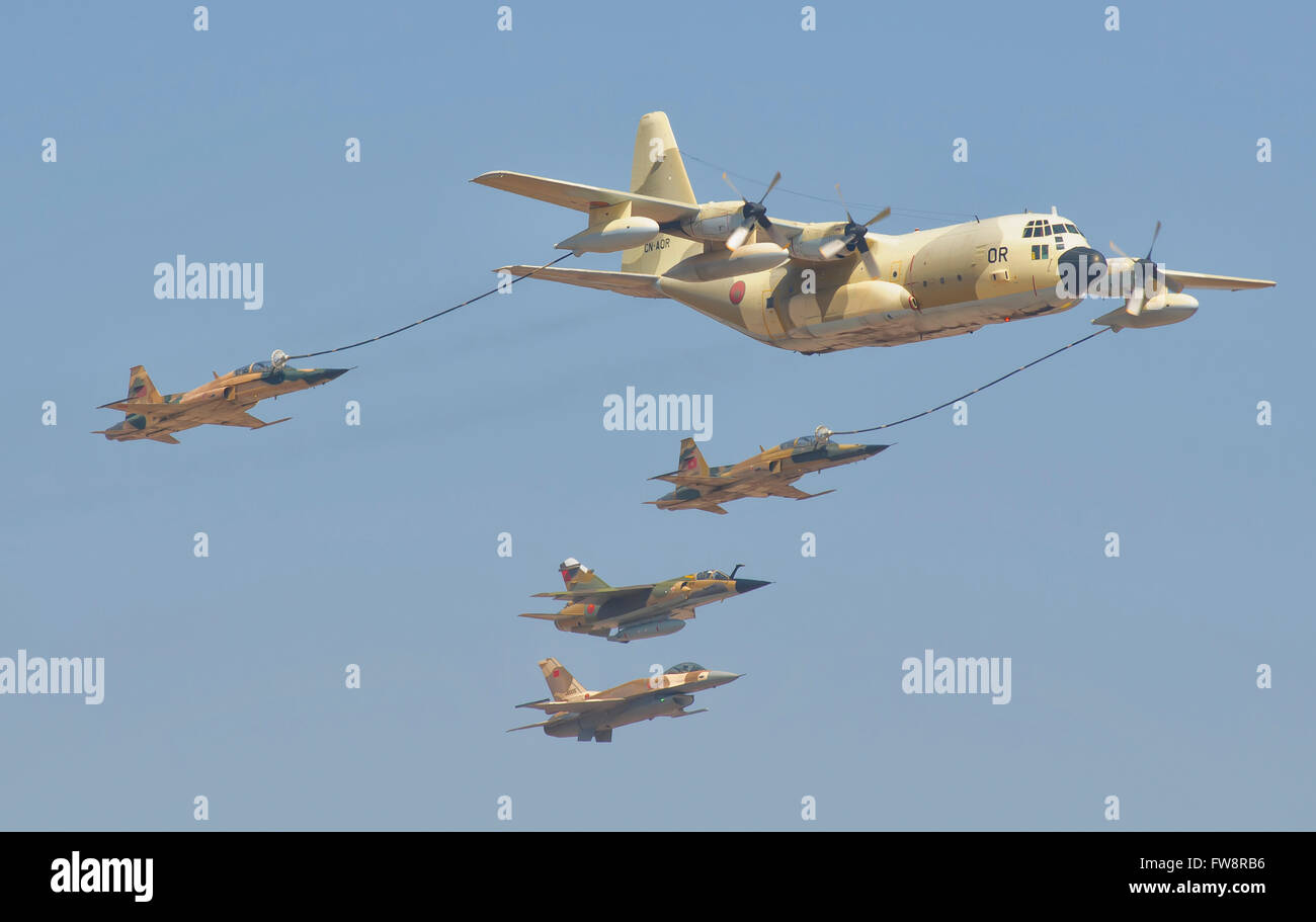 A Royal Moroccan Air Force KC-130 refueling a pair of F-5 aircraft at ...