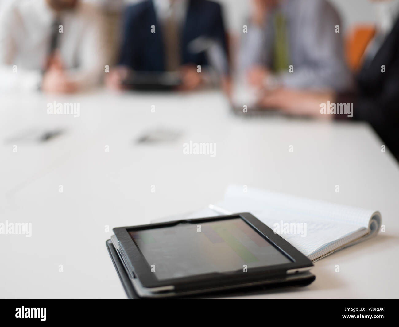 tablet computer with group of people on meeting in background Stock ...