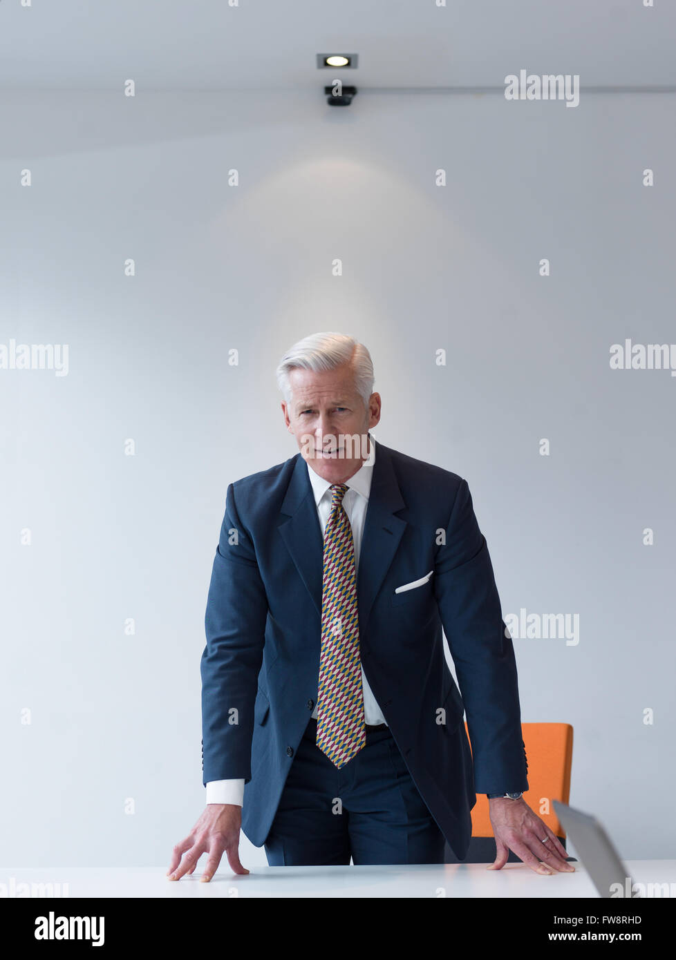 Boss sitting behind desk standing hi-res stock photography and images ...