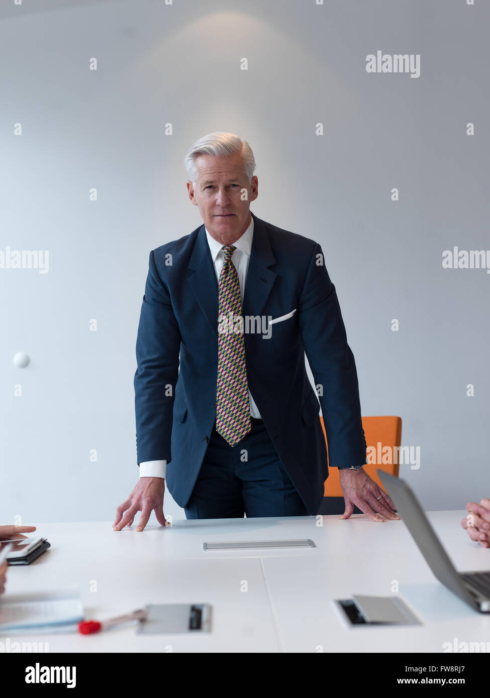 Boss sitting behind desk standing hi-res stock photography and images ...