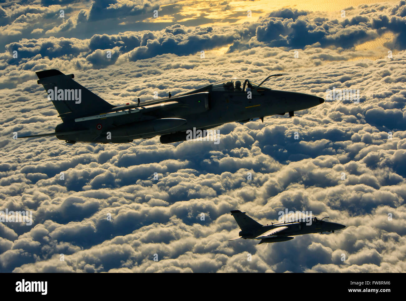 Italian Air Force AMX-ACOL aircraft flying above the clouds during ...