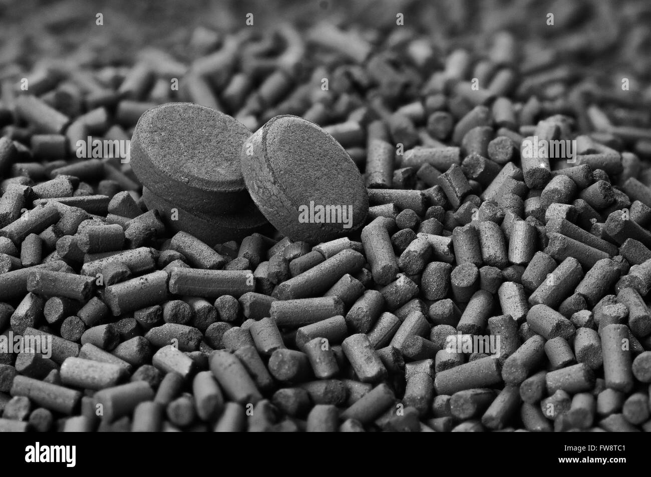 Activated carbon granules and tablets close up Stock Photo - Alamy