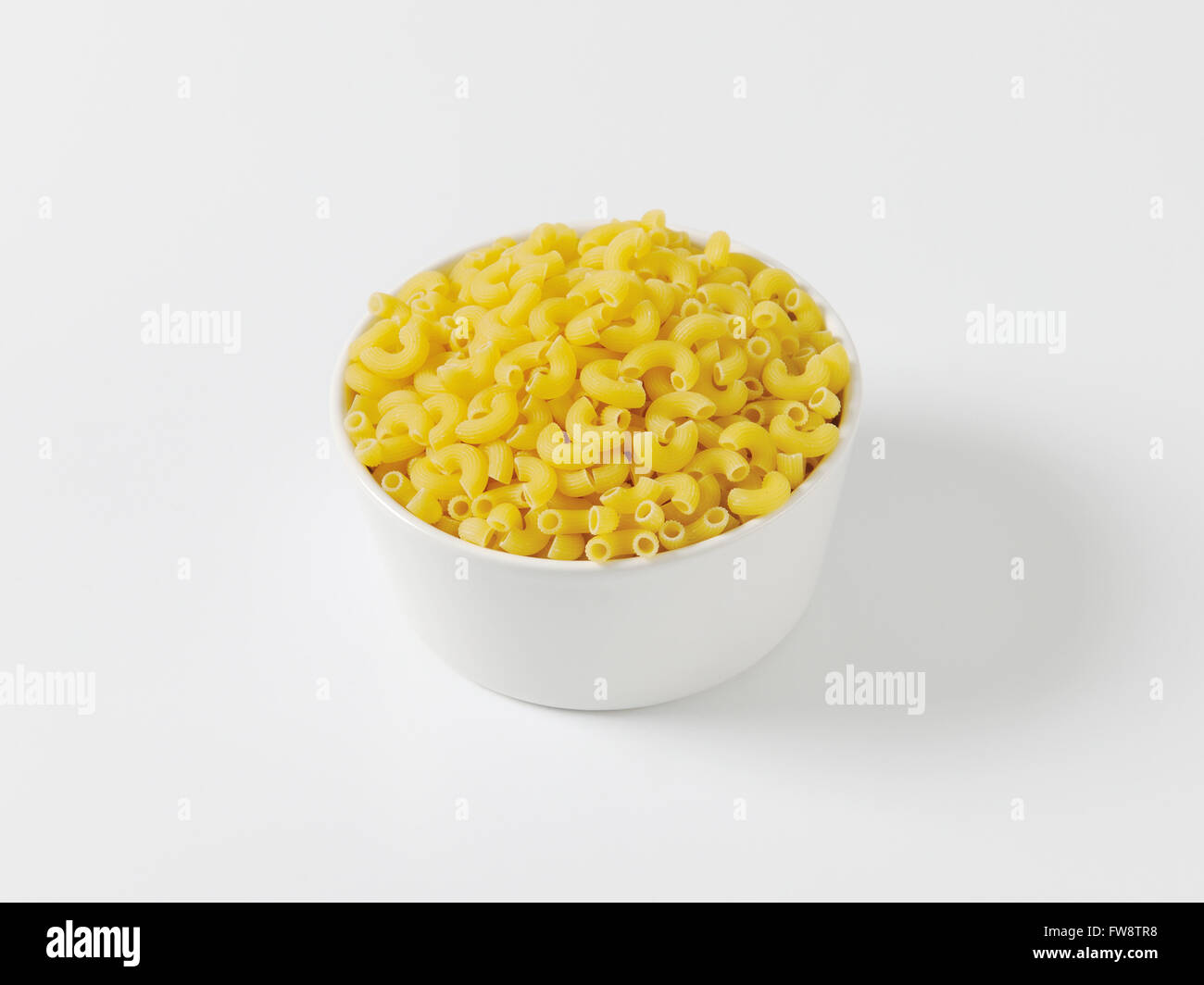 Heap of uncooked macaroni in a bowl Stock Photo - Alamy