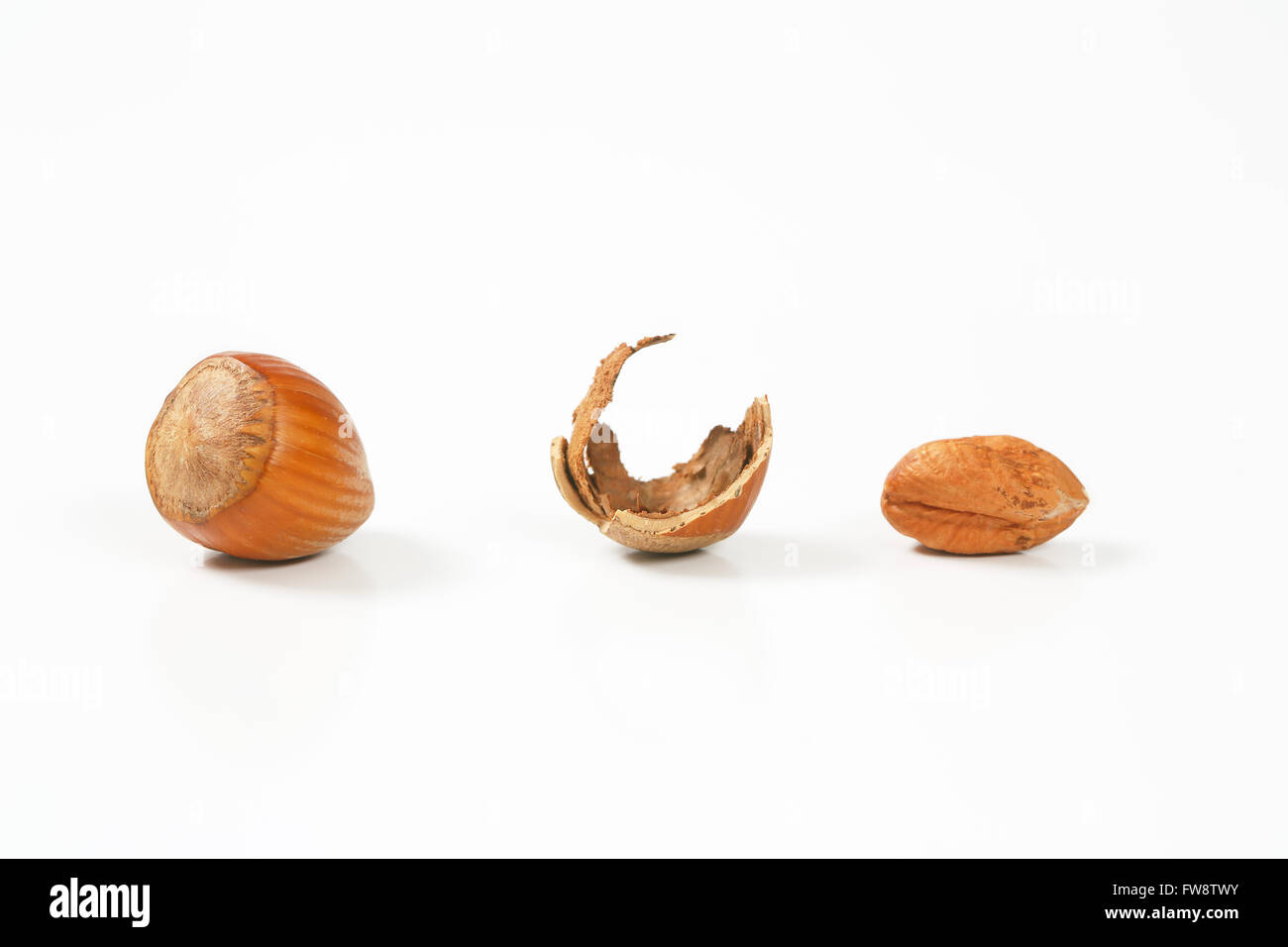 whole and cracked hazelnuts on white background Stock Photo - Alamy
