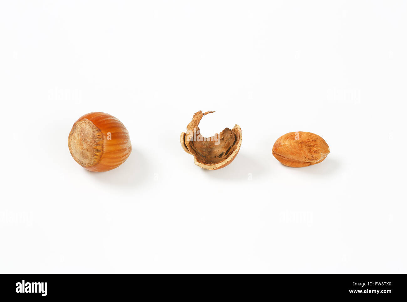 whole and cracked hazelnuts on white background Stock Photo - Alamy