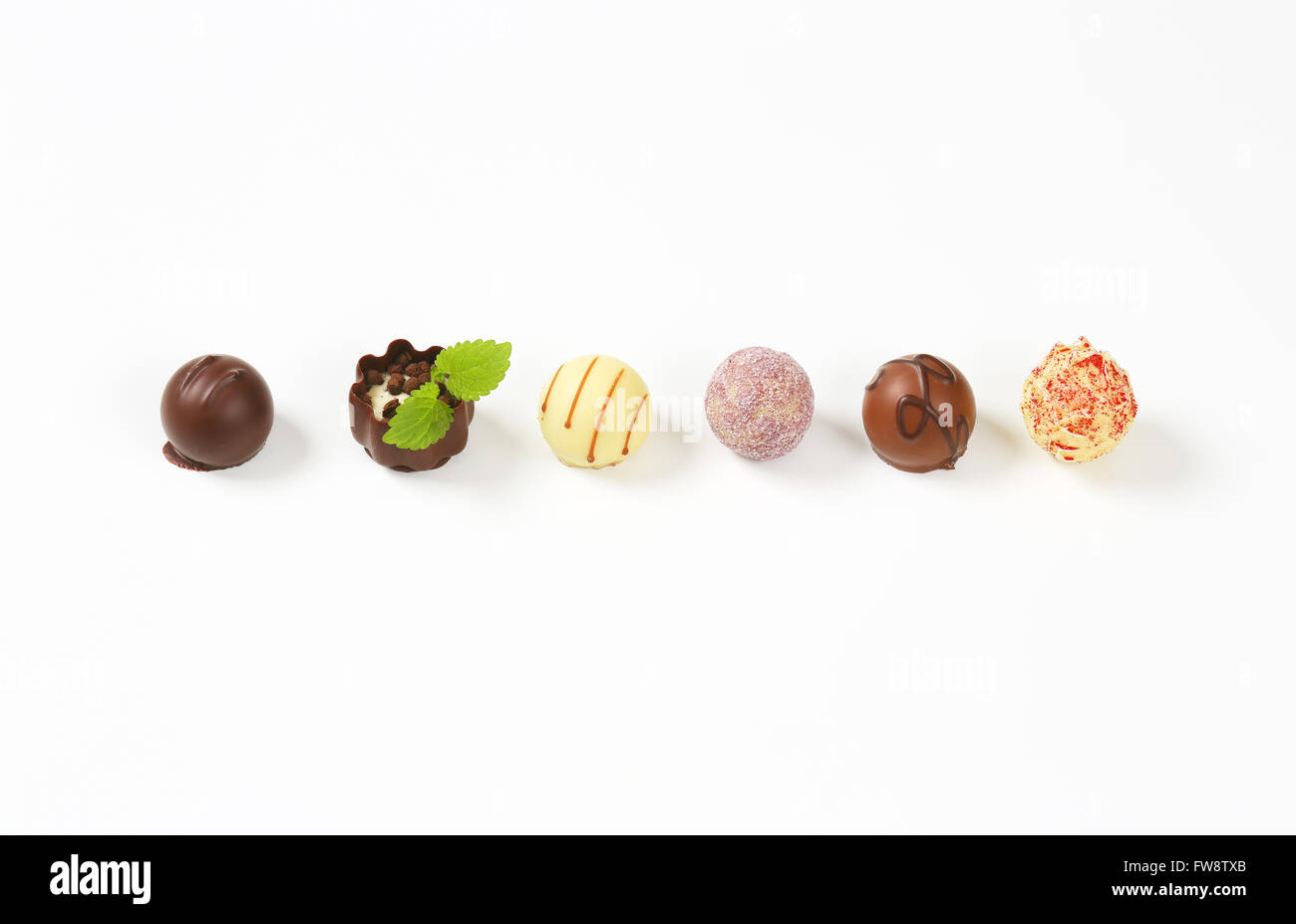 line of assorted belgian chocolate pralines on white background Stock ...
