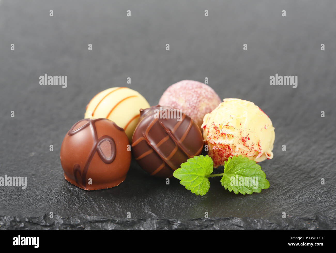assorted belgian chocolate pralines on black background Stock Photo - Alamy