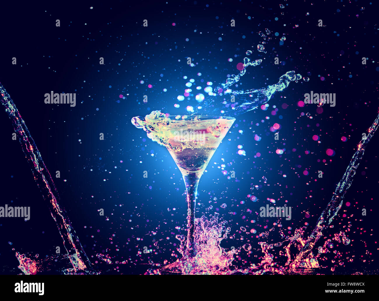 Colourful cocktail in glass with splash Stock Photo - Alamy