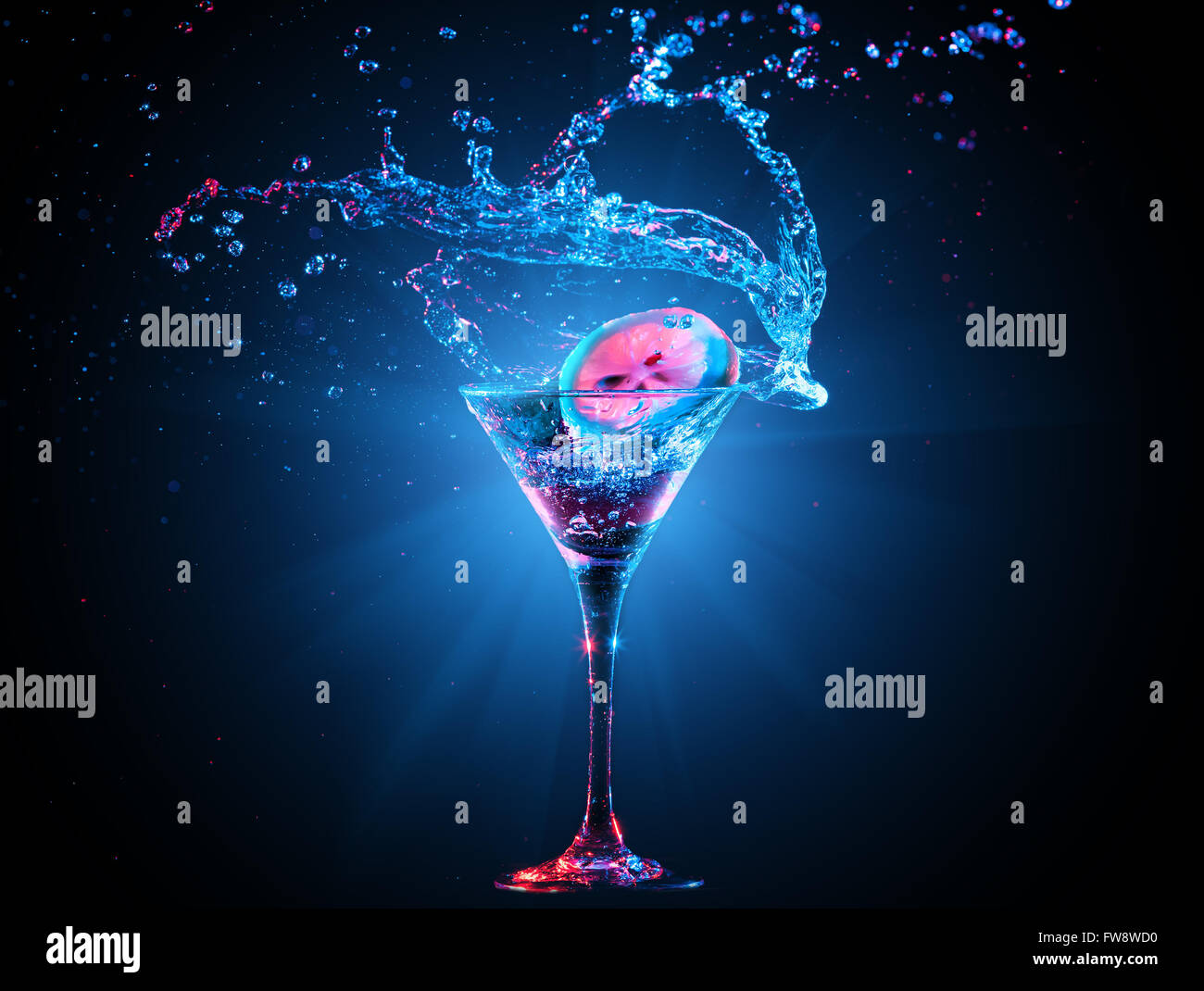 Colourful cocktail in glass with splash Stock Photo - Alamy