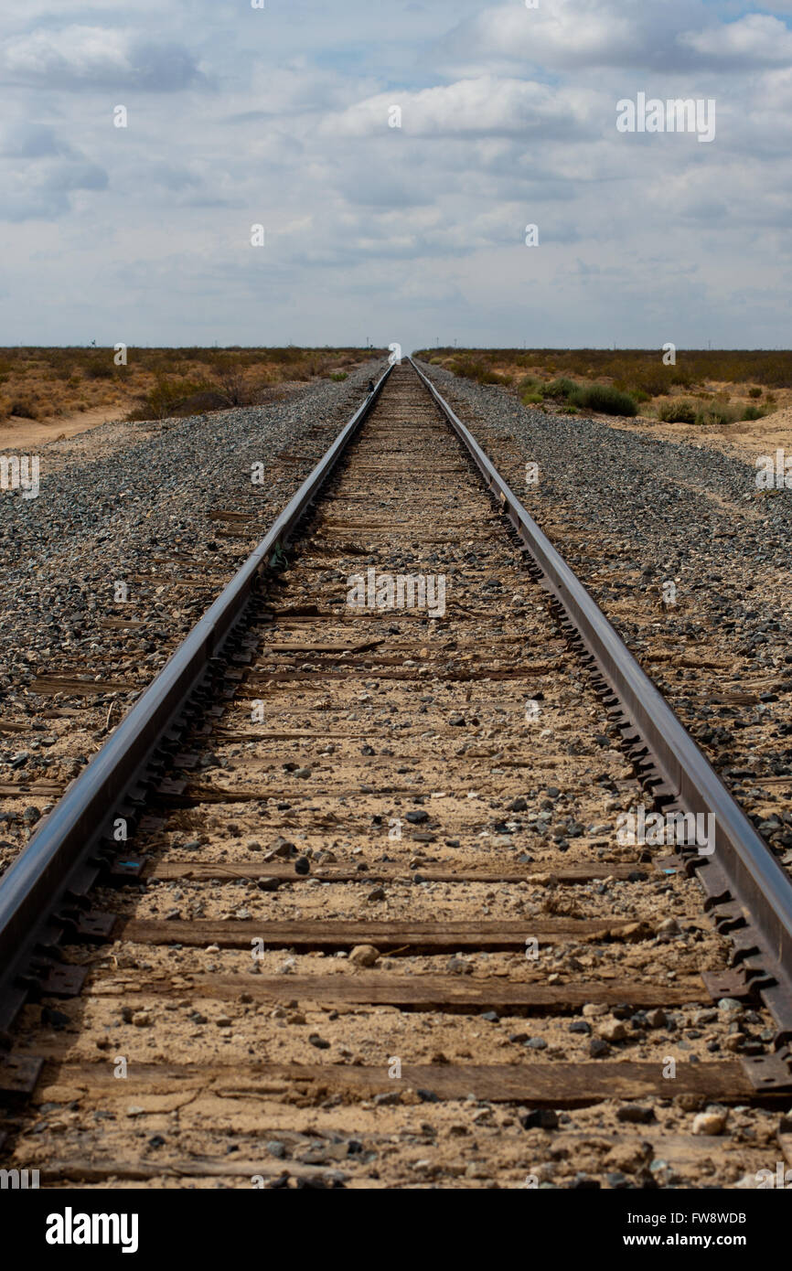 A view along a long, straight rail track in the USA Stock Photo - Alamy