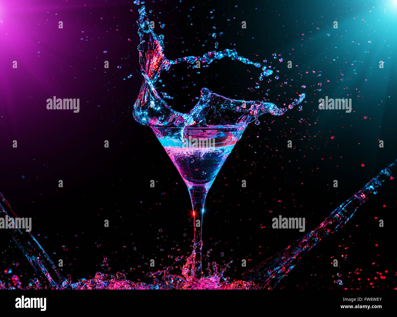 Colourful cocktail in glass with splash Stock Photo - Alamy