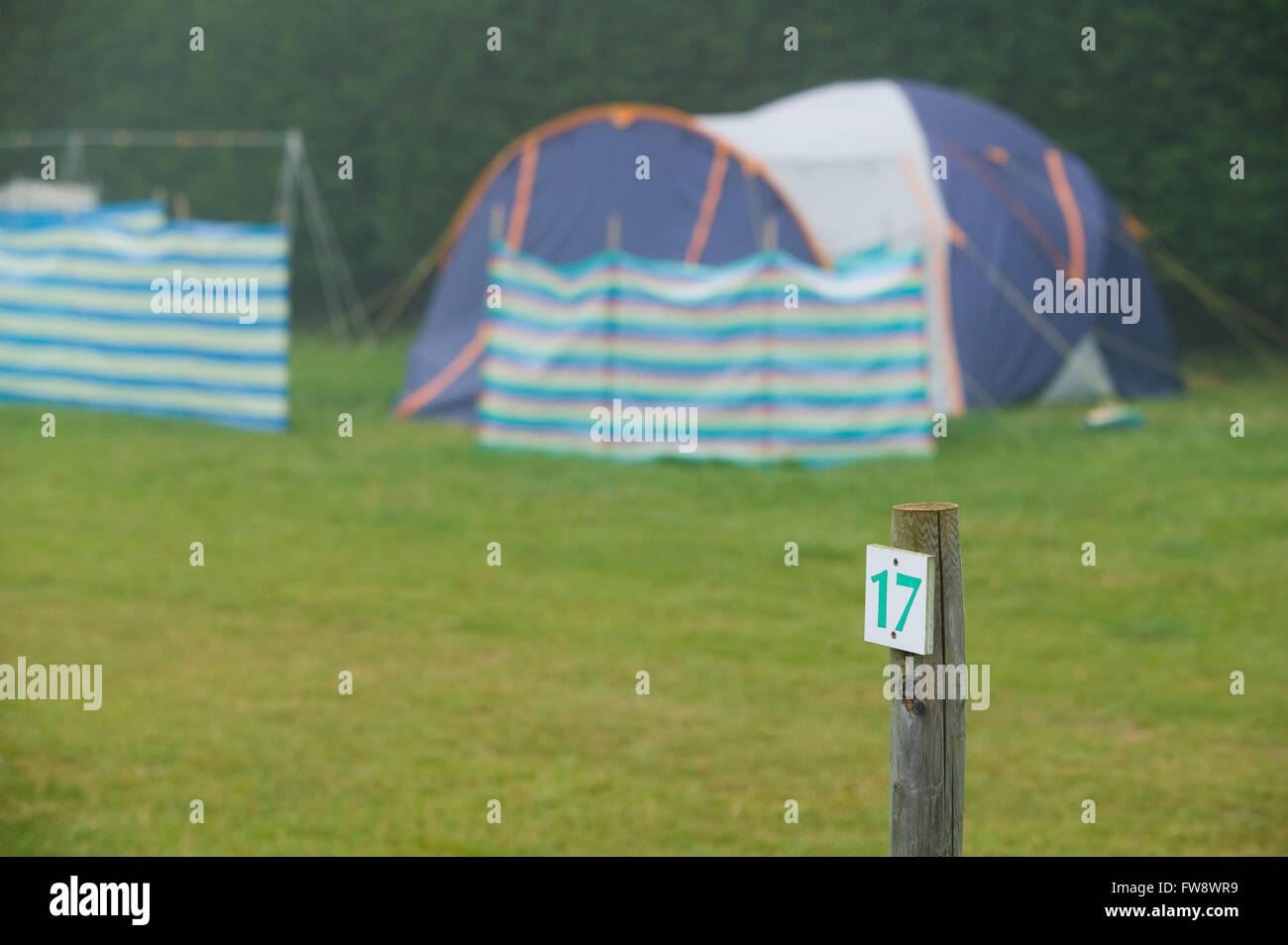 A pole sets out the space on a campsite where a family tent or caravan ...