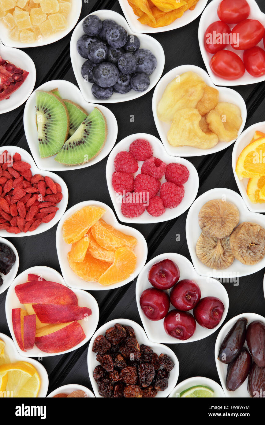 Fresh and dried mixed fruit super food selection in heart shaped bowls ...