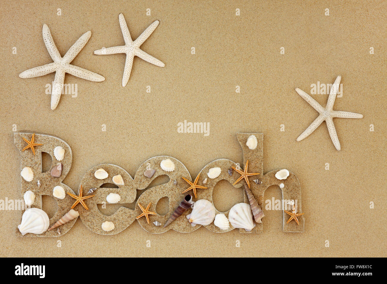 Beach sign with sea shells and starfish in sand forming a background ...