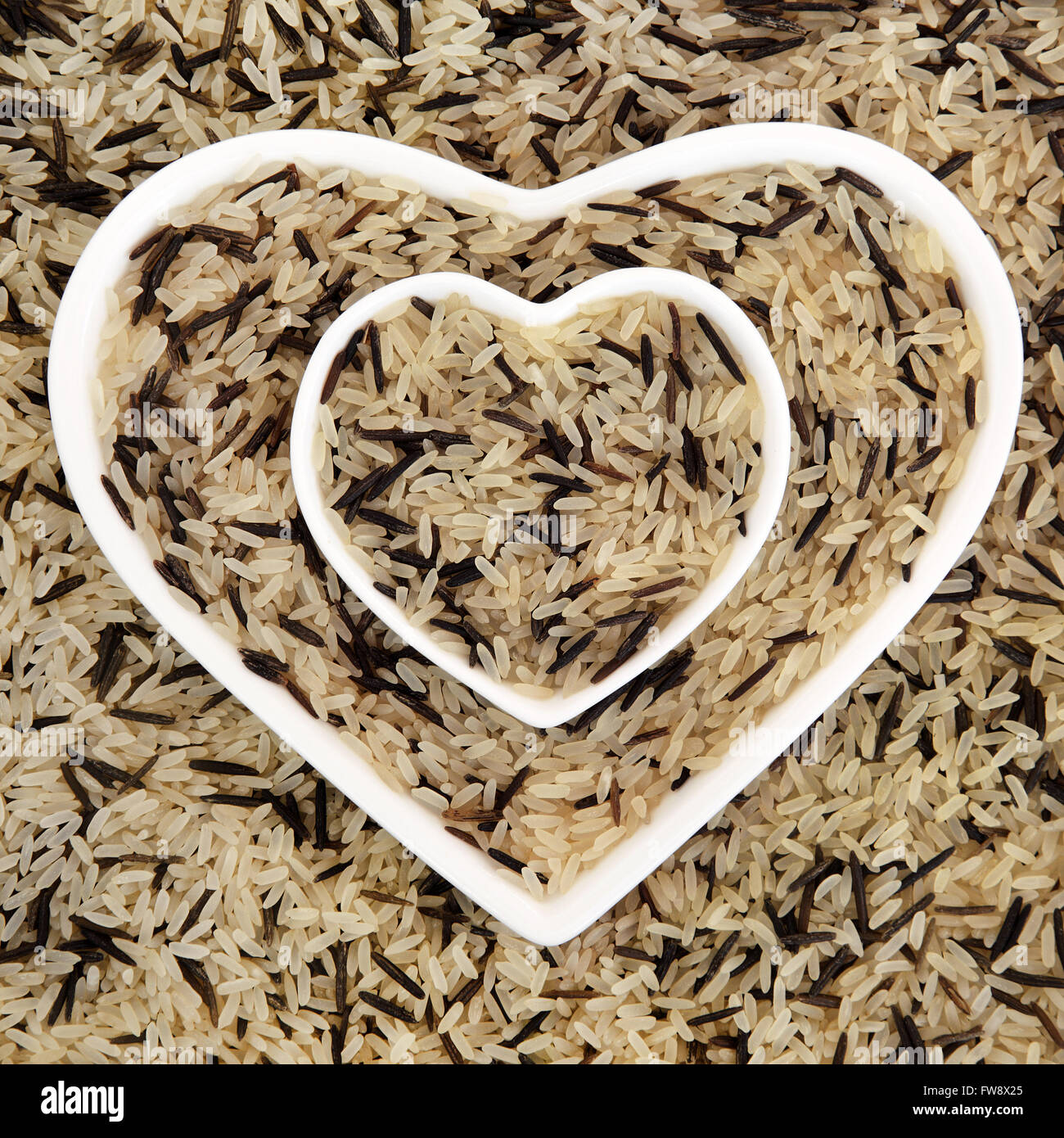 Long grain wild rice in heart shaped porcelain dishes forming an ...