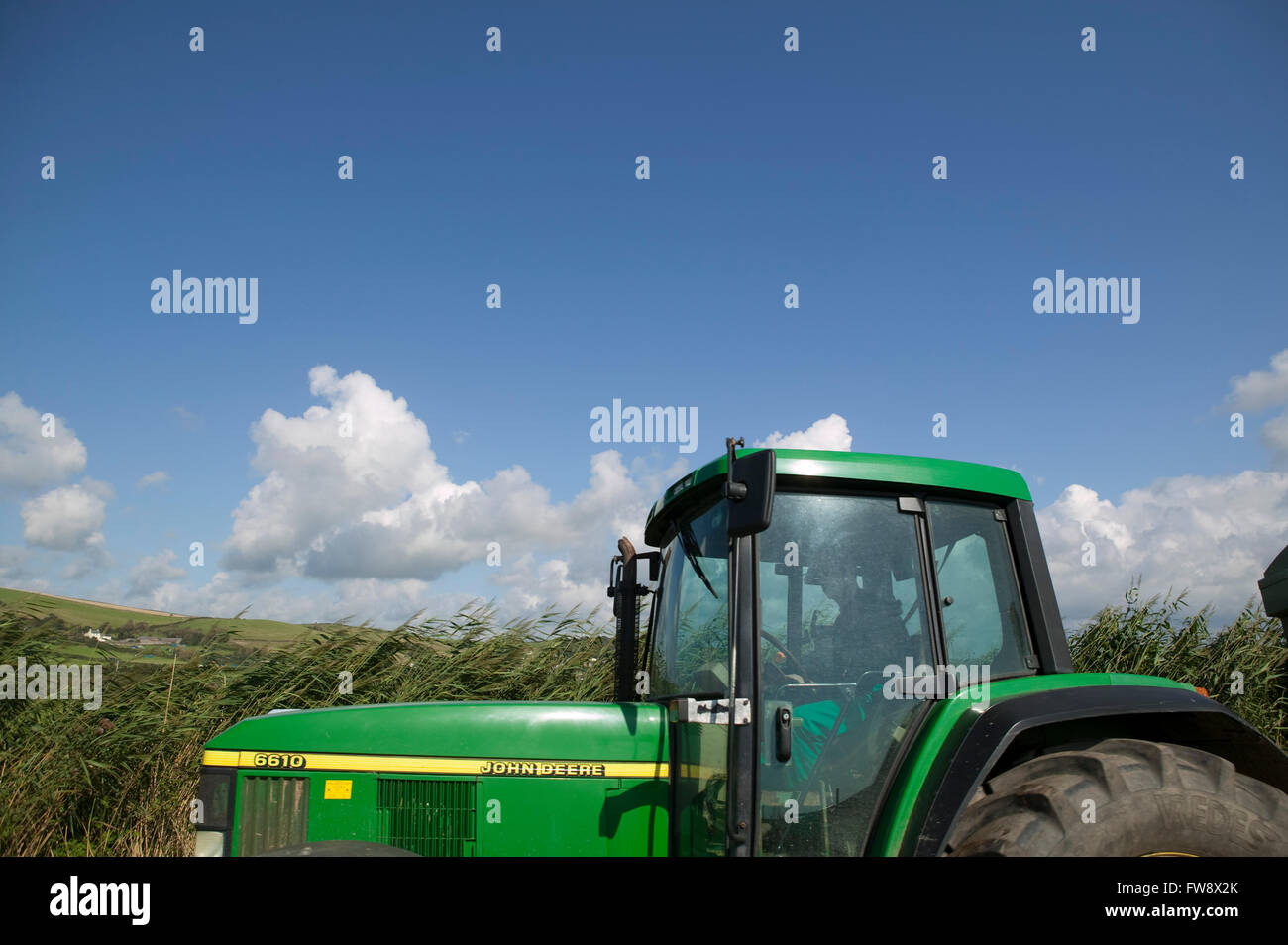 A fram tractor passes by after working in the fields collecting crops ...