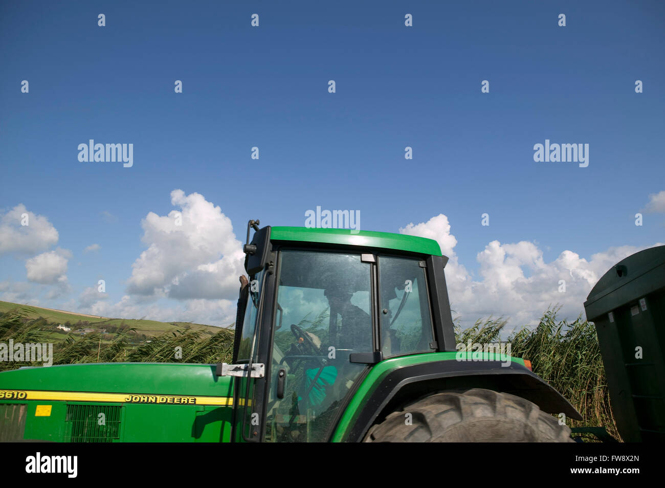 A fram tractor passes by after working in the fields collecting crops ...