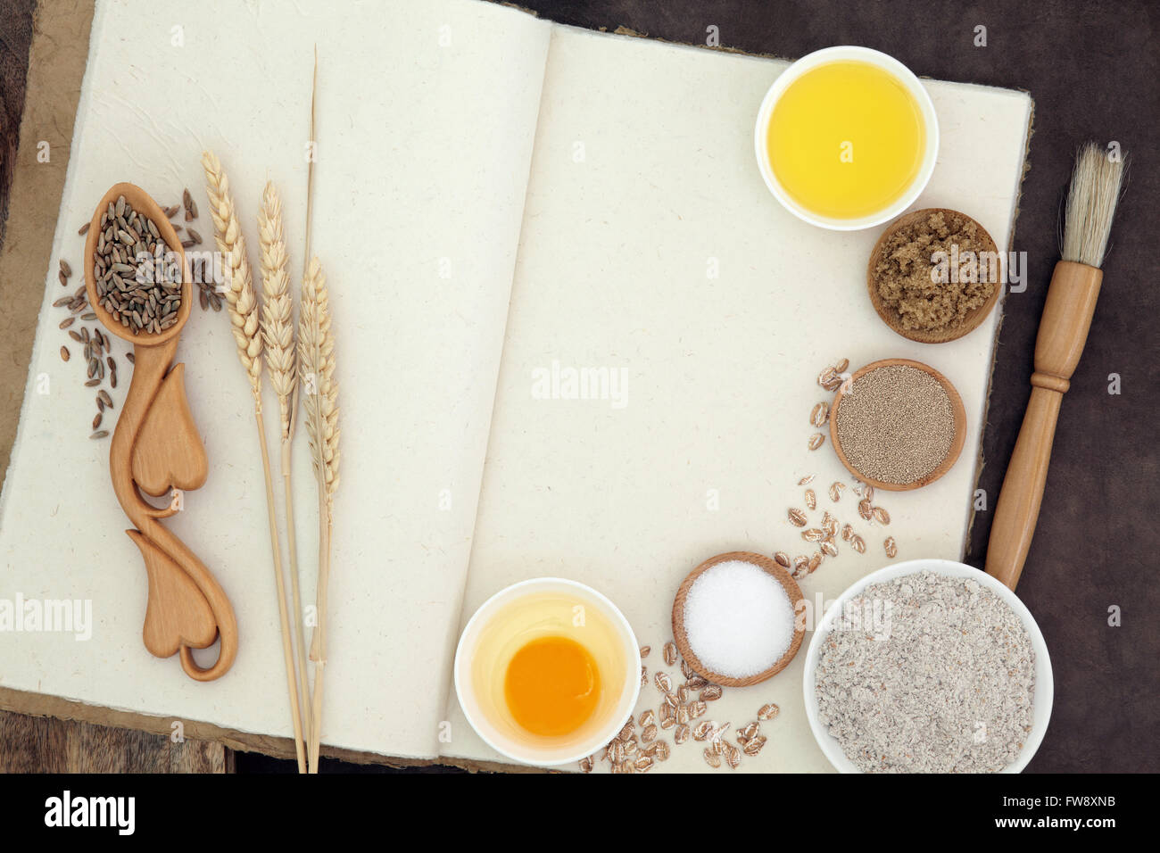Baking ingredients and utensils on hemp notebook, old wooden board and ...