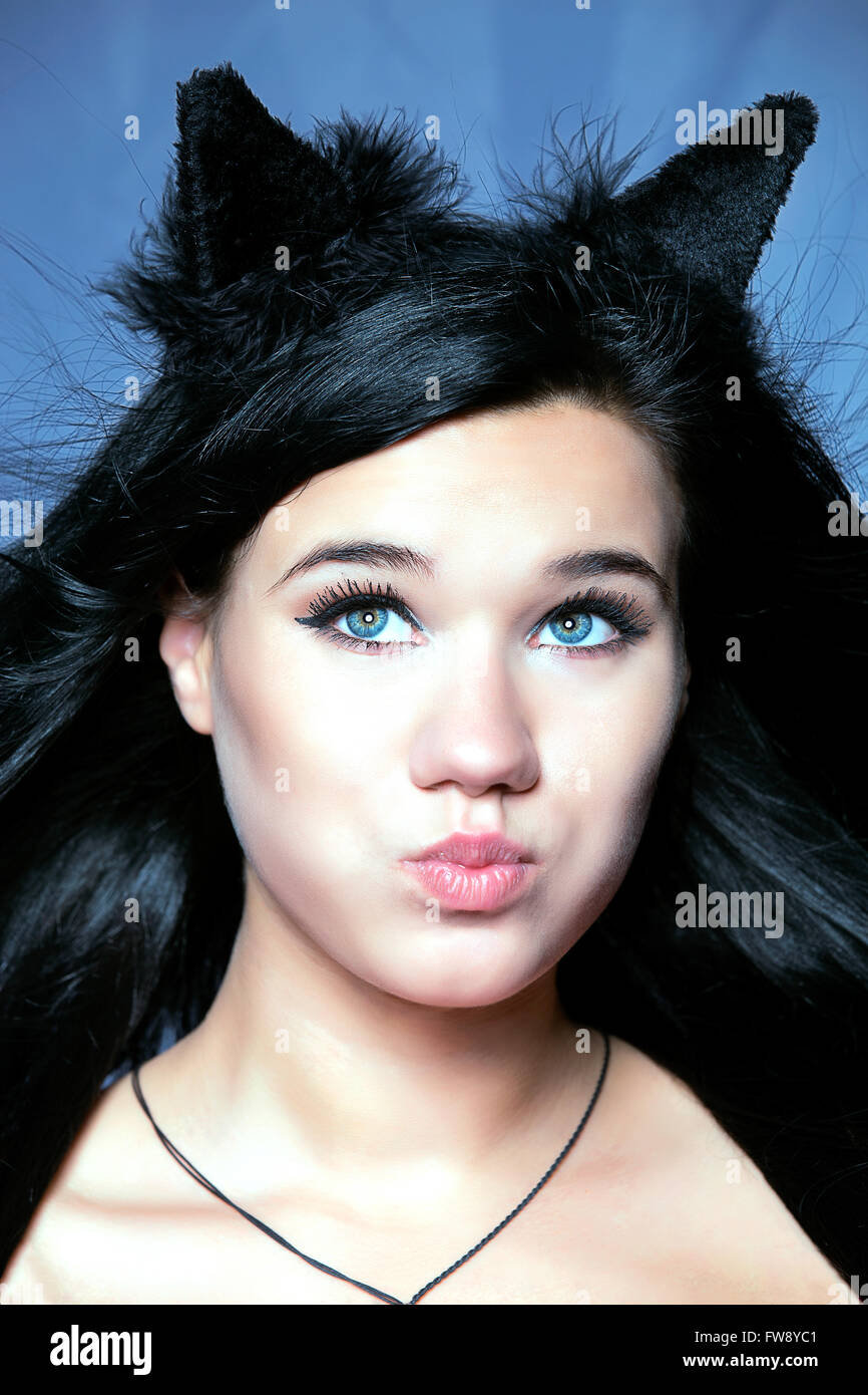 Close studio portrait of a girl with cat ears, girl with beautiful blue ...