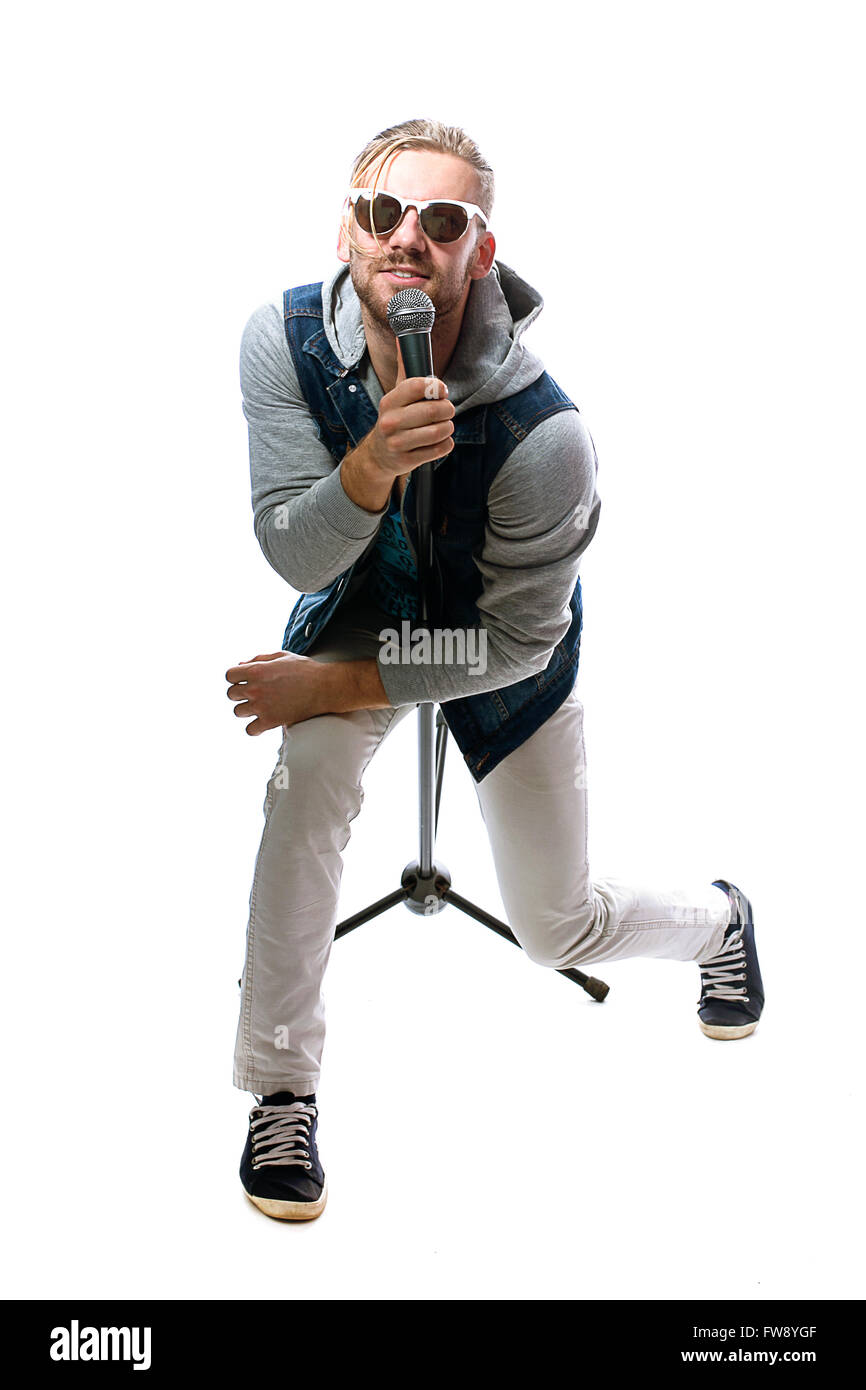 studio portrait of a man singing with microphone isolated on white ...