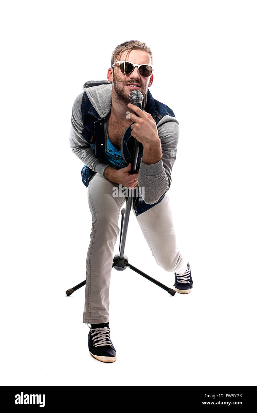studio portrait of a man singing with microphone isolated on white ...