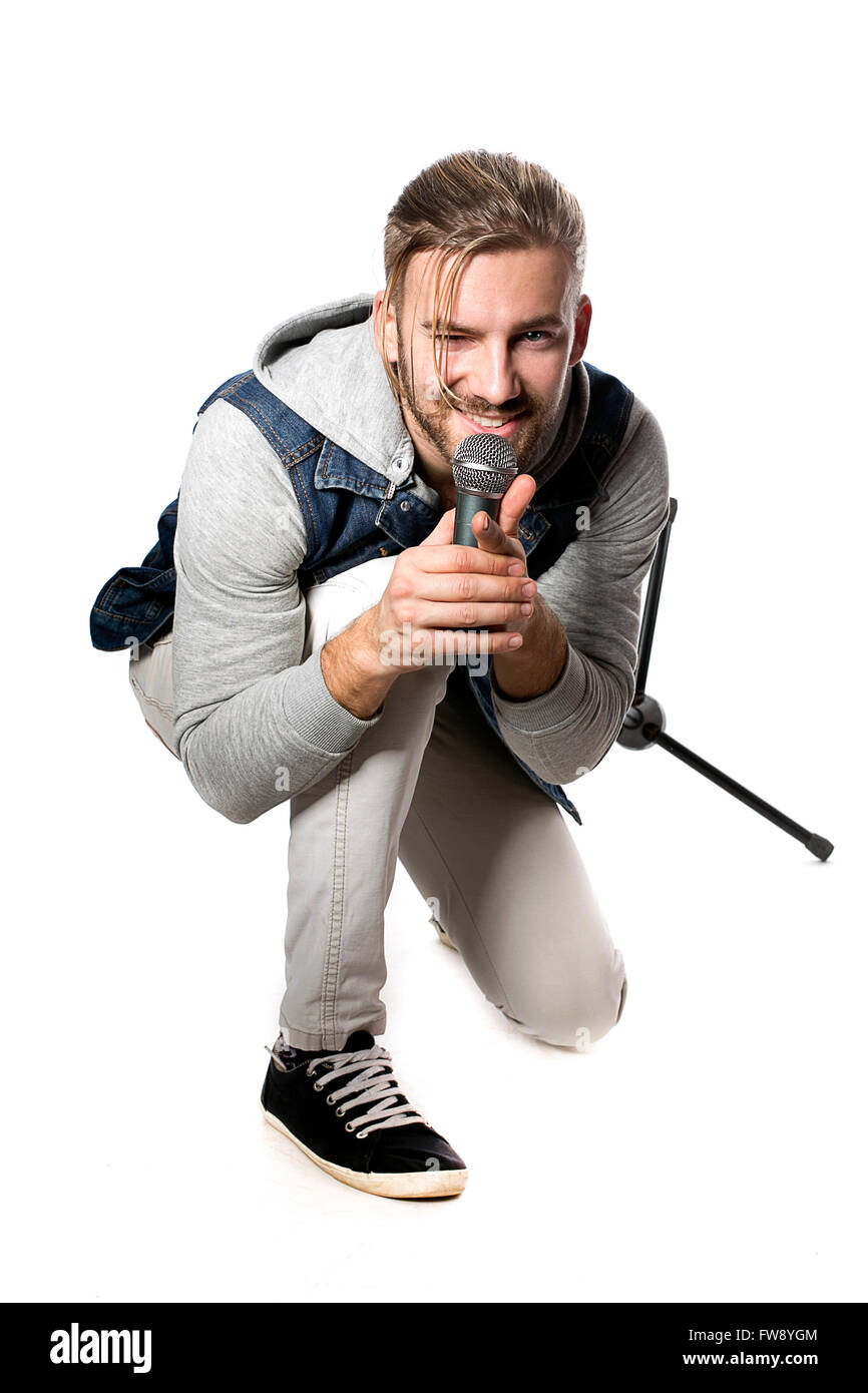studio portrait of a man singing with microphone isolated on white ...