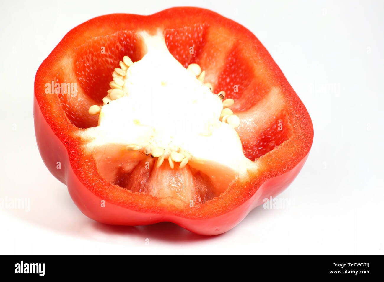 Closeup split red bell pepper fresh on white background Stock Photo - Alamy
