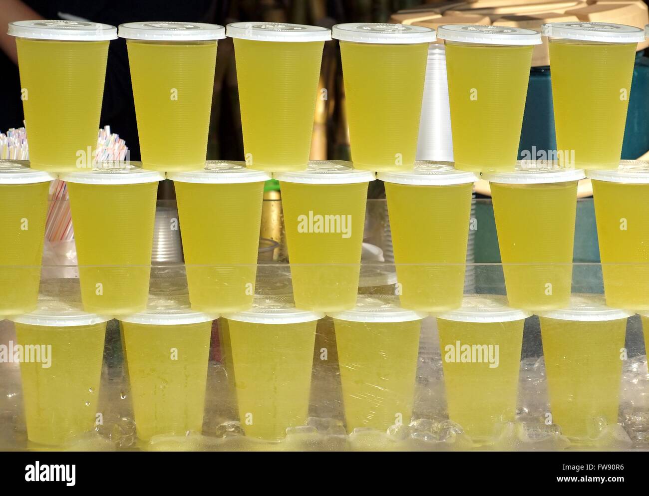 Plastic cups with juice stacked up at an outdoor stall Stock Photo - Alamy