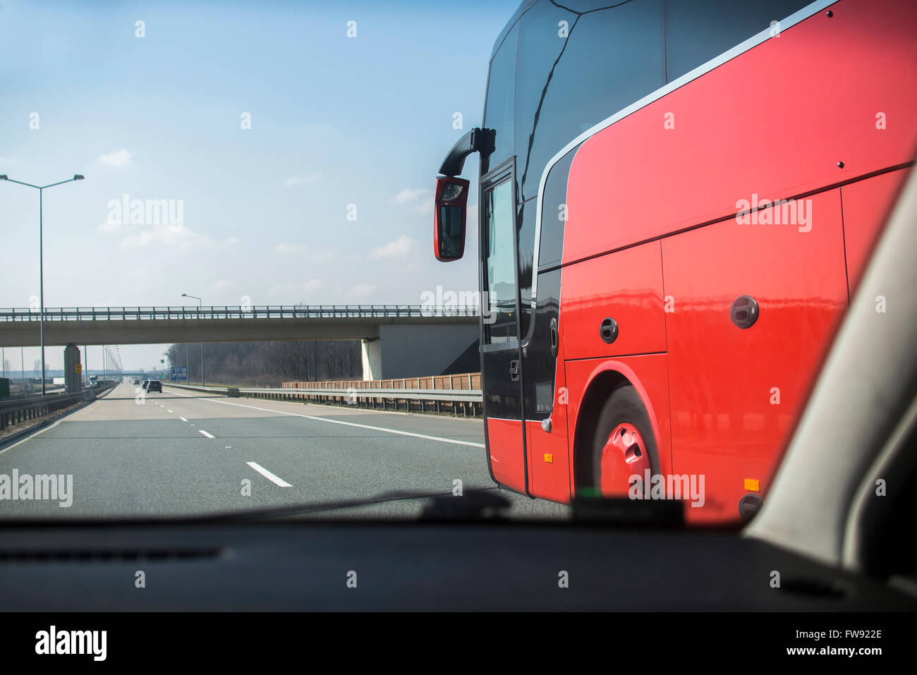 Driving a car in highway with bus Stock Photo - Alamy
